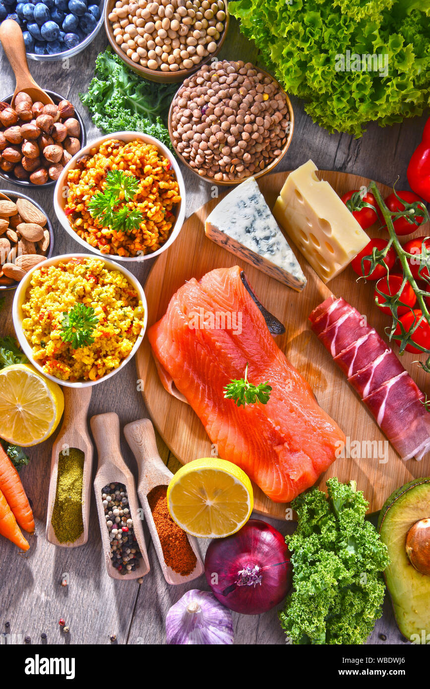 Composition with assorted food products on kitchen table Stock Photo ...