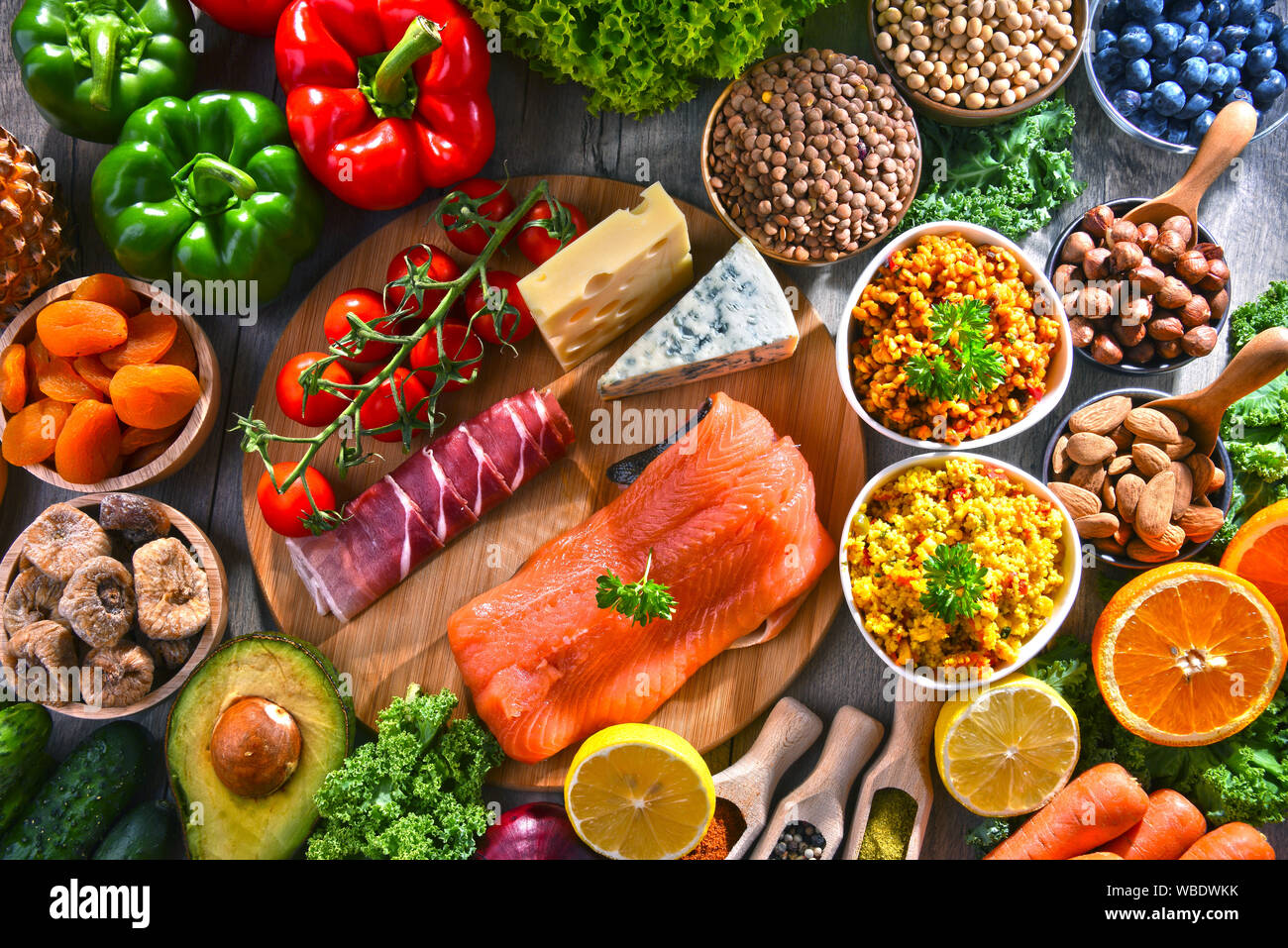 Composition with assorted food products on kitchen table Stock Photo ...