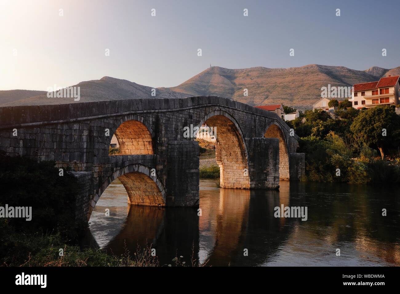 Soft yellow sunlight lights up the arches of the picturesque ...