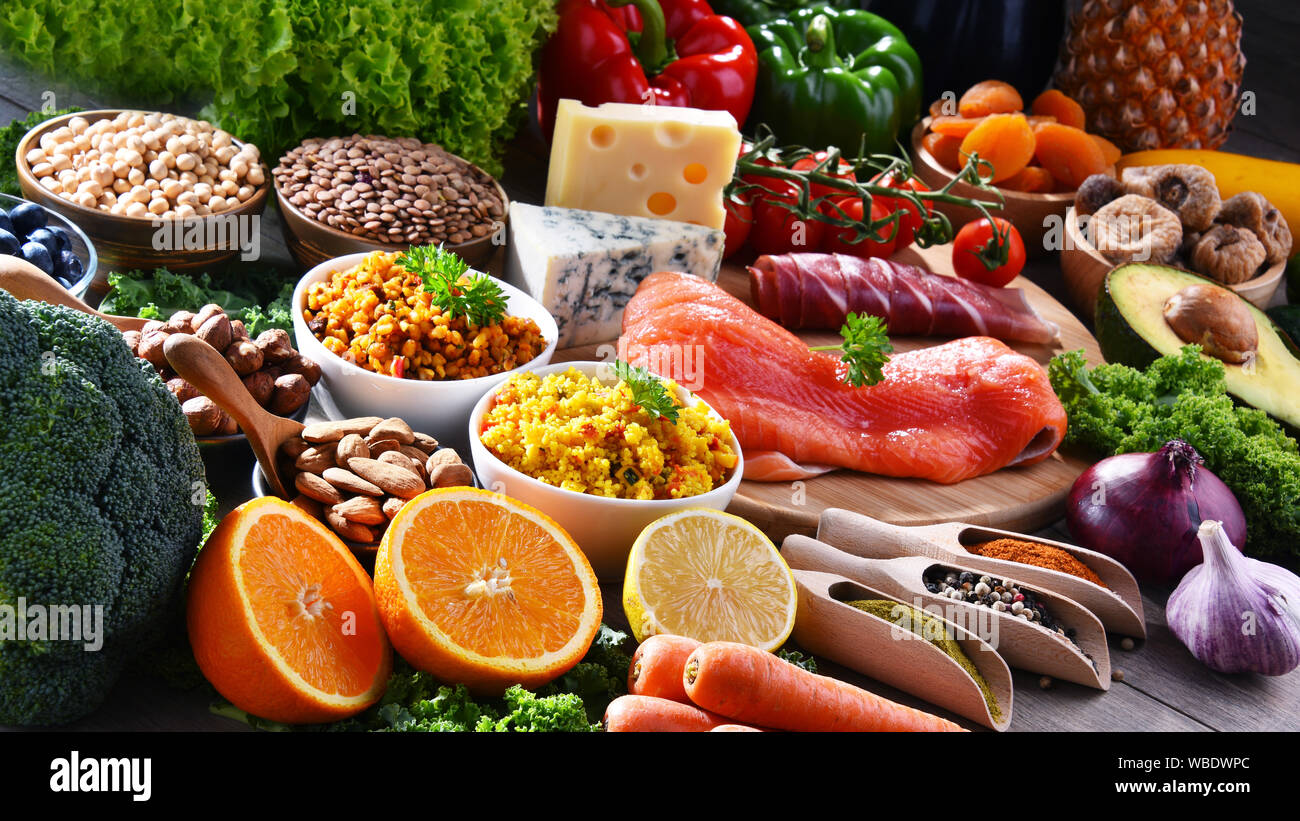 Composition with assorted food products on kitchen table Stock Photo ...