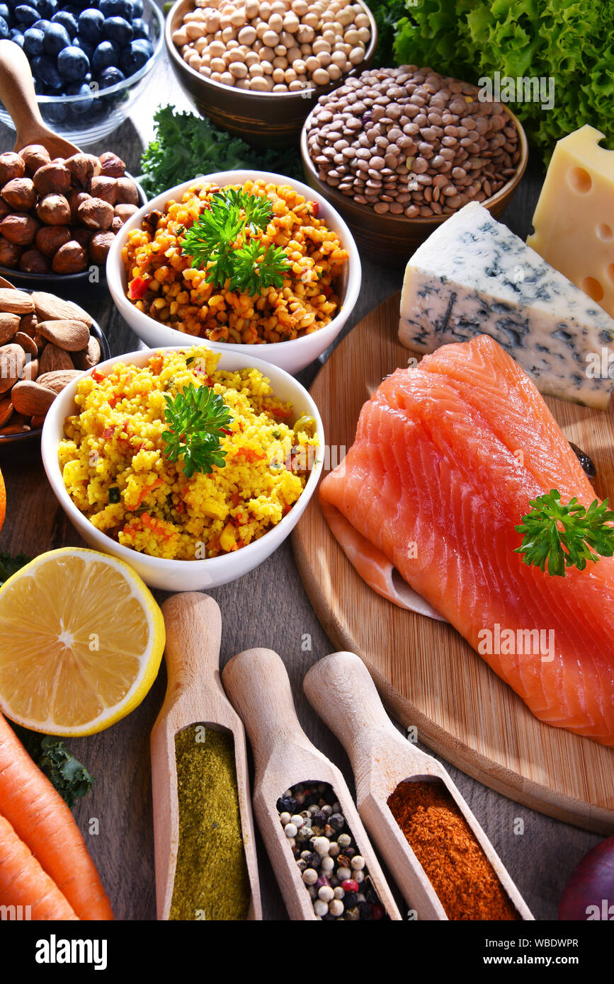Composition with assorted food products on kitchen table Stock Photo ...