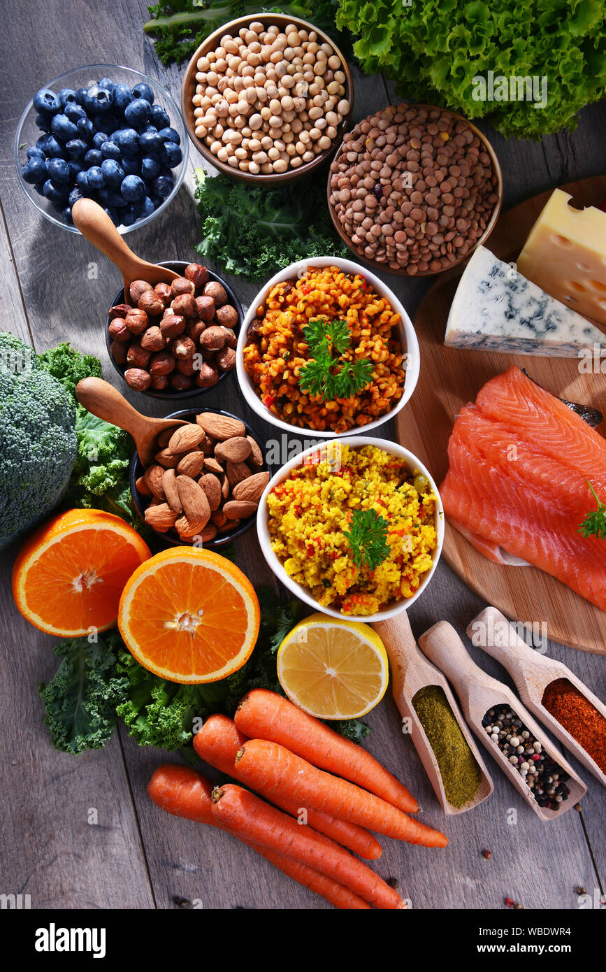Composition with assorted food products on kitchen table Stock Photo ...