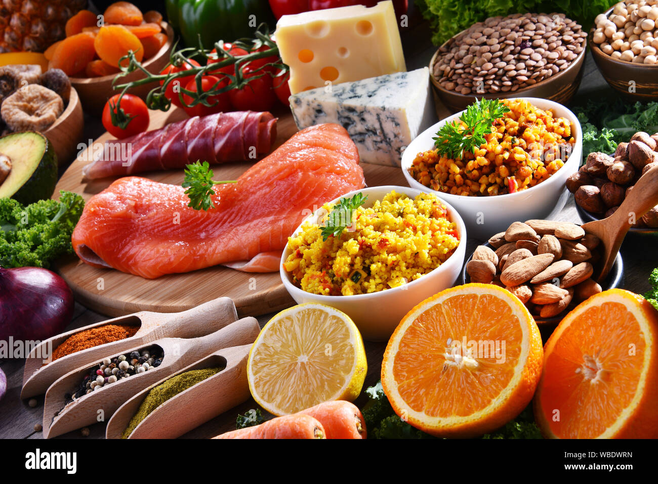 Composition with assorted food products on kitchen table Stock Photo ...
