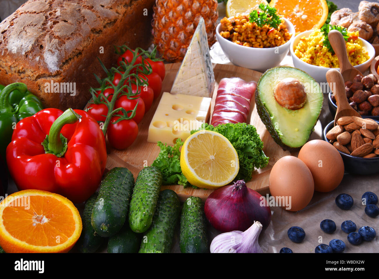 Composition with assorted food products on kitchen table Stock Photo ...