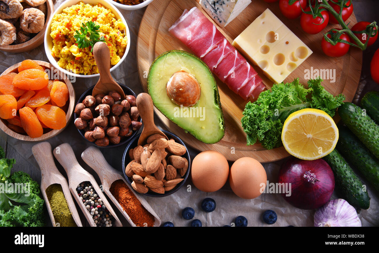 Composition with assorted food products on kitchen table Stock Photo ...