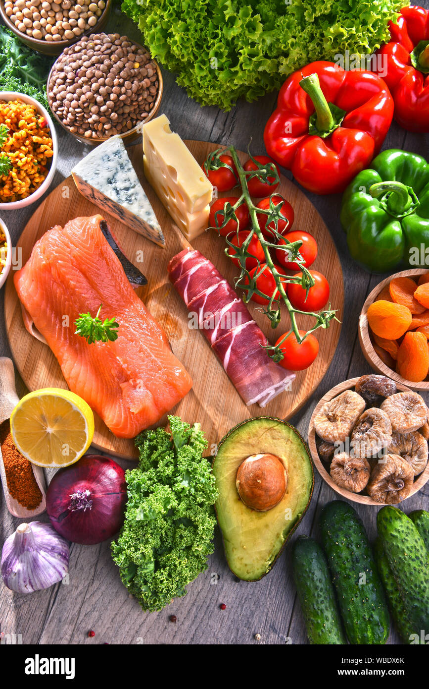 Composition with assorted food products on kitchen table Stock Photo ...