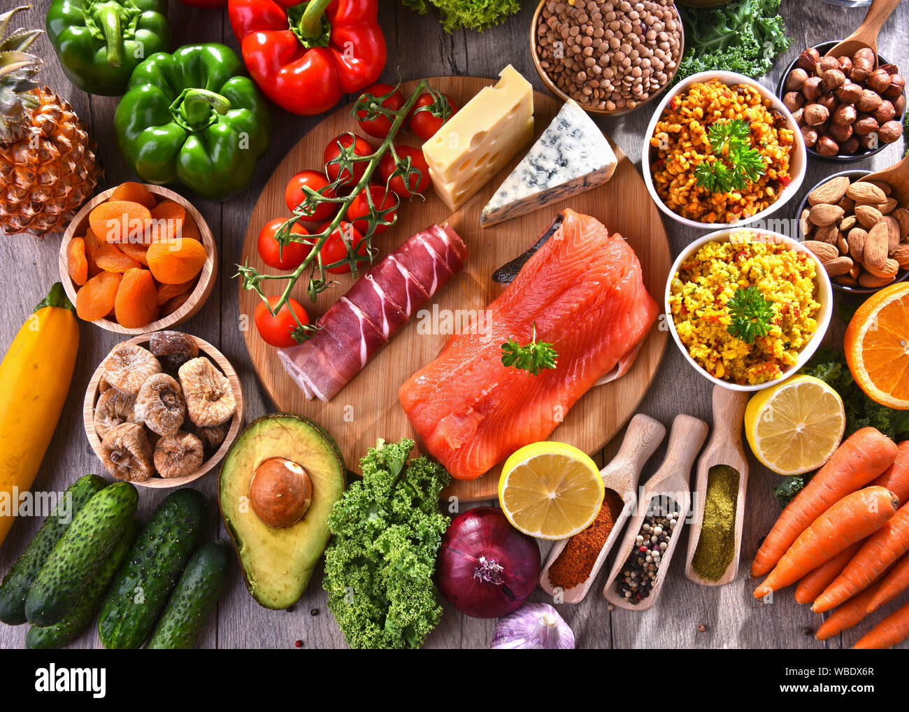 Composition with assorted food products on kitchen table Stock Photo ...