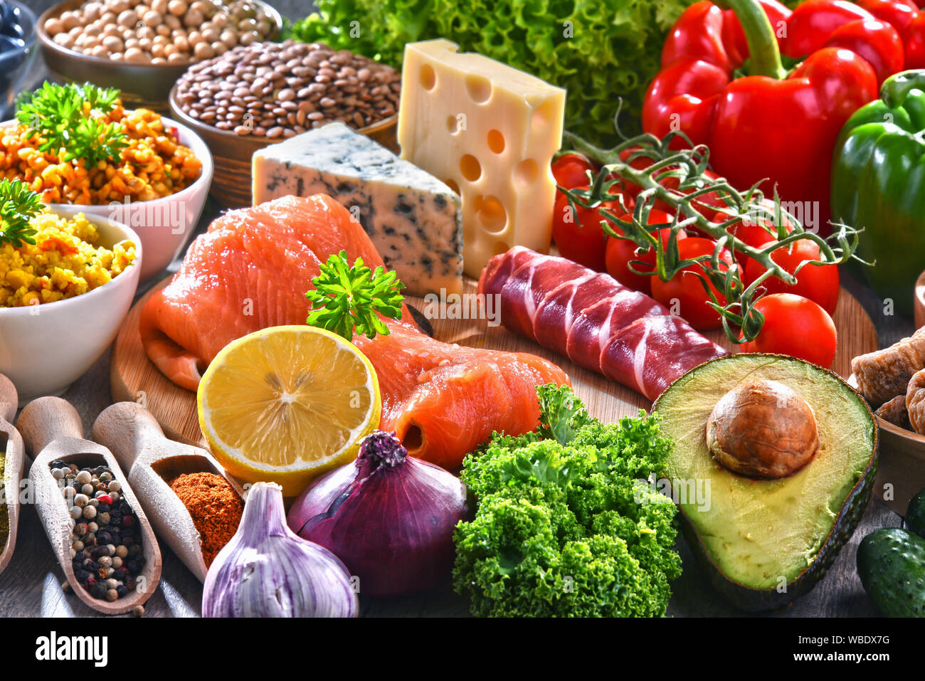 Composition with assorted food products on kitchen table Stock Photo ...