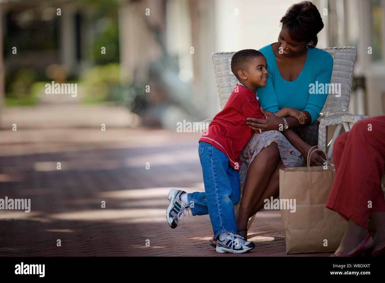 Mid-adult woman being hugged by her son Stock Photo - Alamy