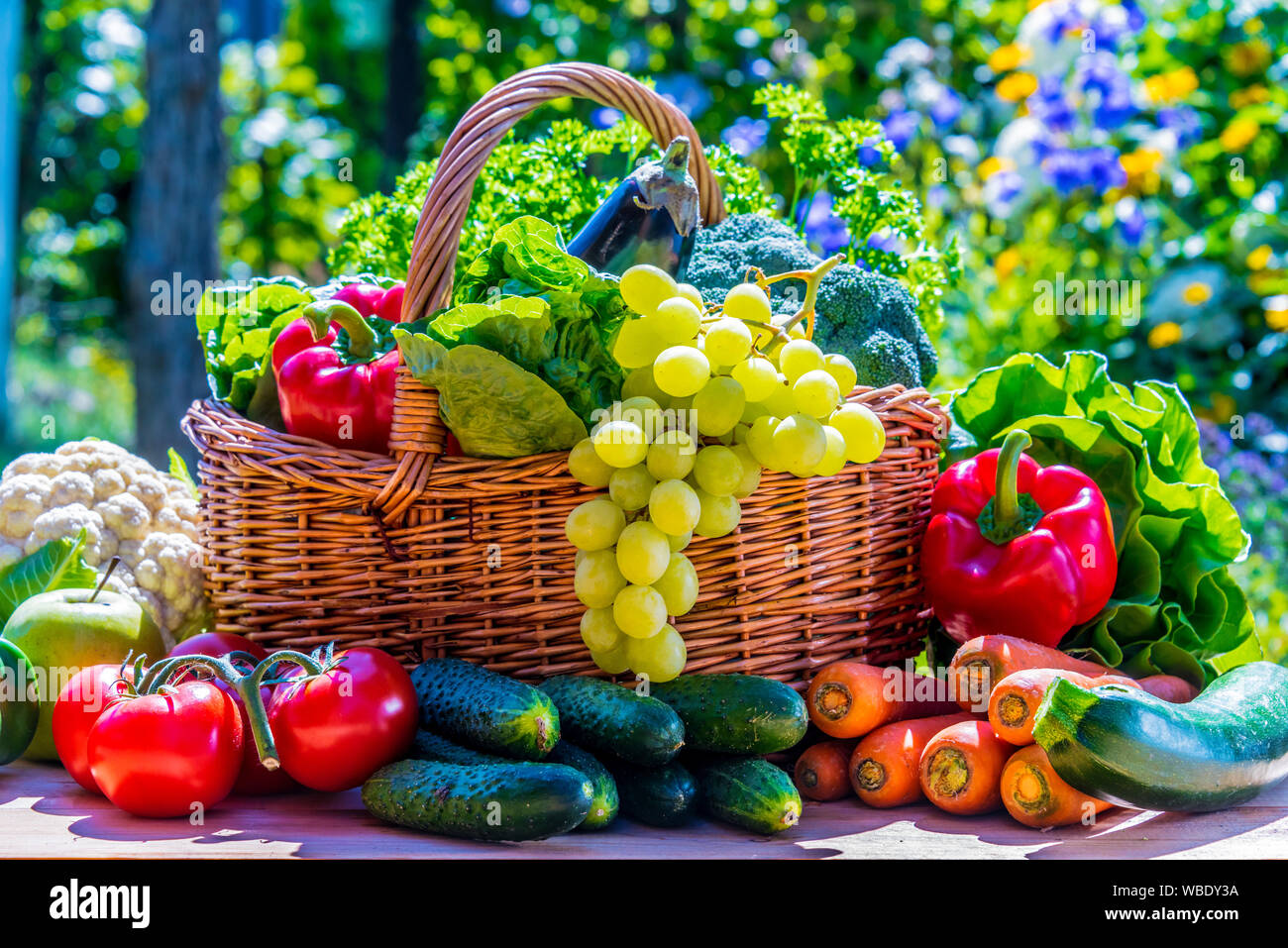 Variety of fresh organic vegetables and fruits in the garden. Balanced ...