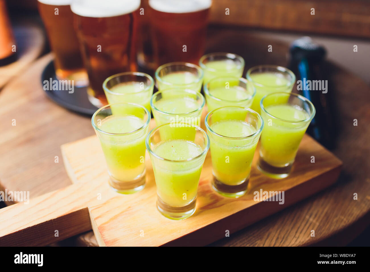 Multicolour alcoholic shots on wooden tray in nightclub Stock Photo - Alamy