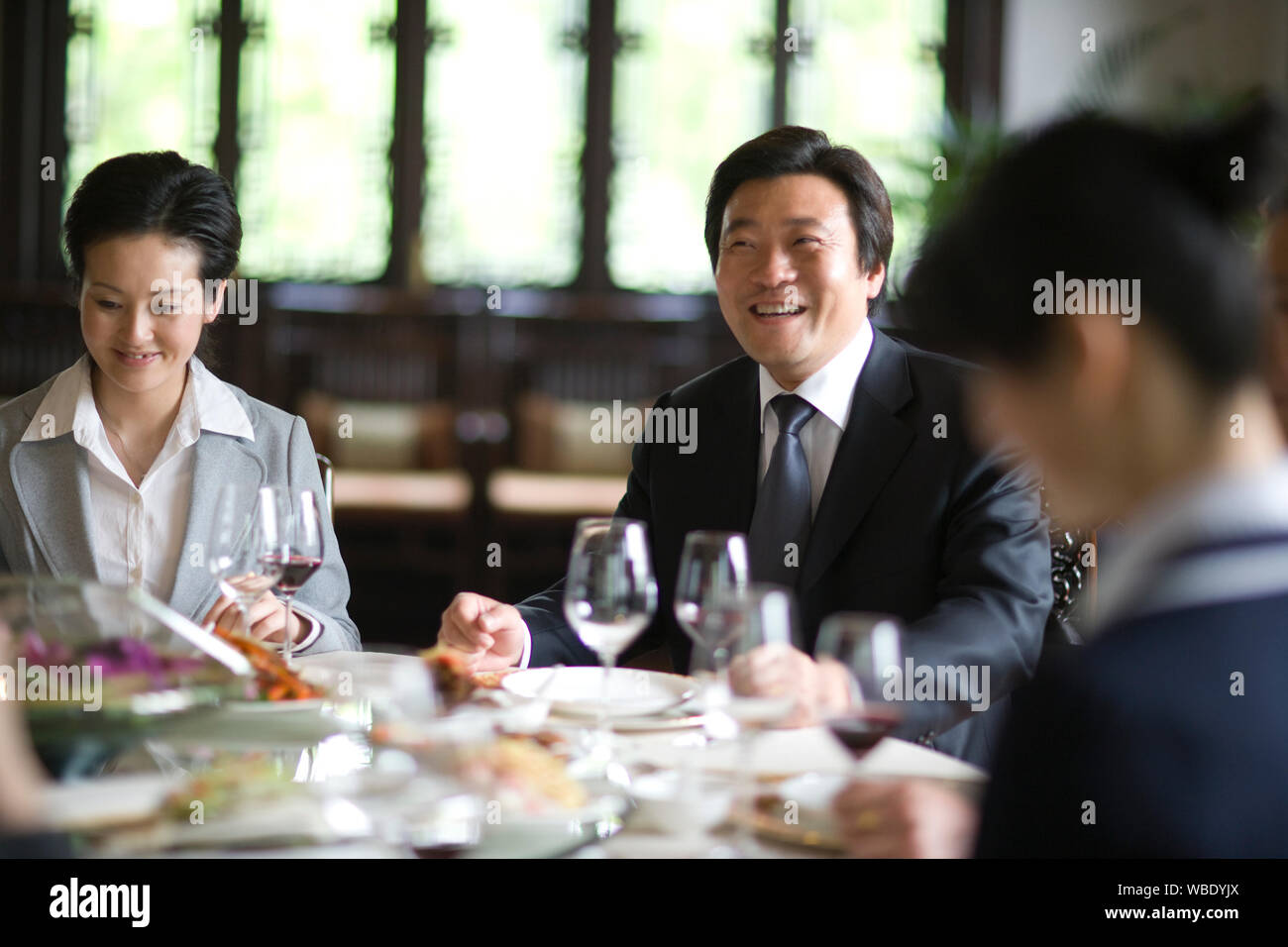 Business colleagues enjoying a lunch inside a restaurant Stock Photo ...