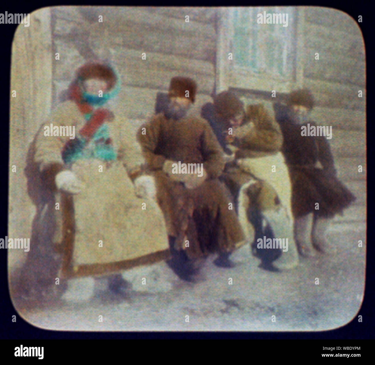 Four convicts sitting against house Stock Photo - Alamy