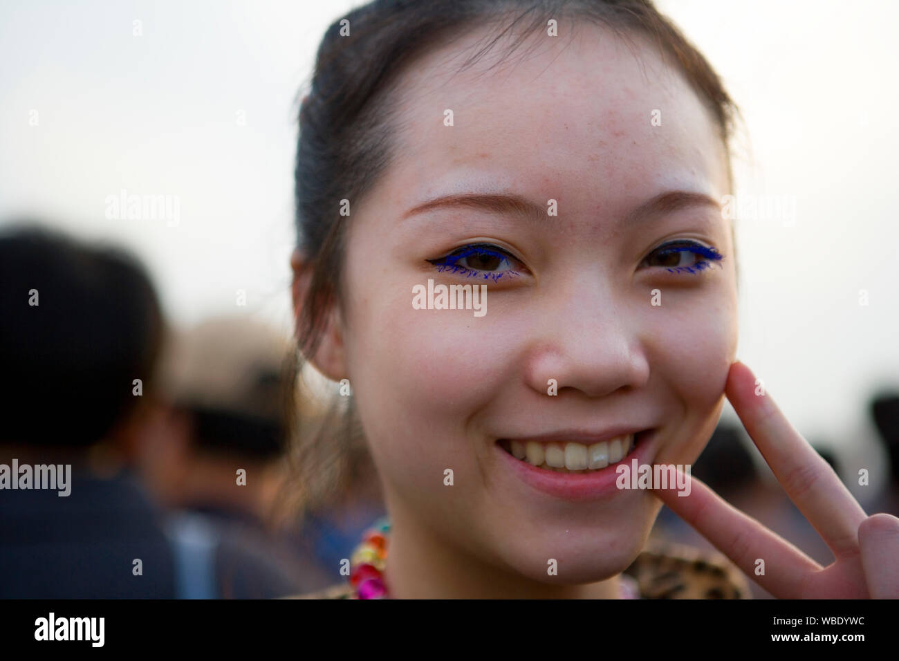 Portrait of a smiling teenage girl wearing blue mascara Stock Photo - Alamy