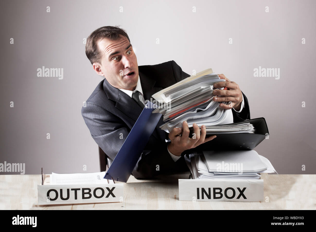 Stressed office worker pile paper hi-res stock photography and images ...