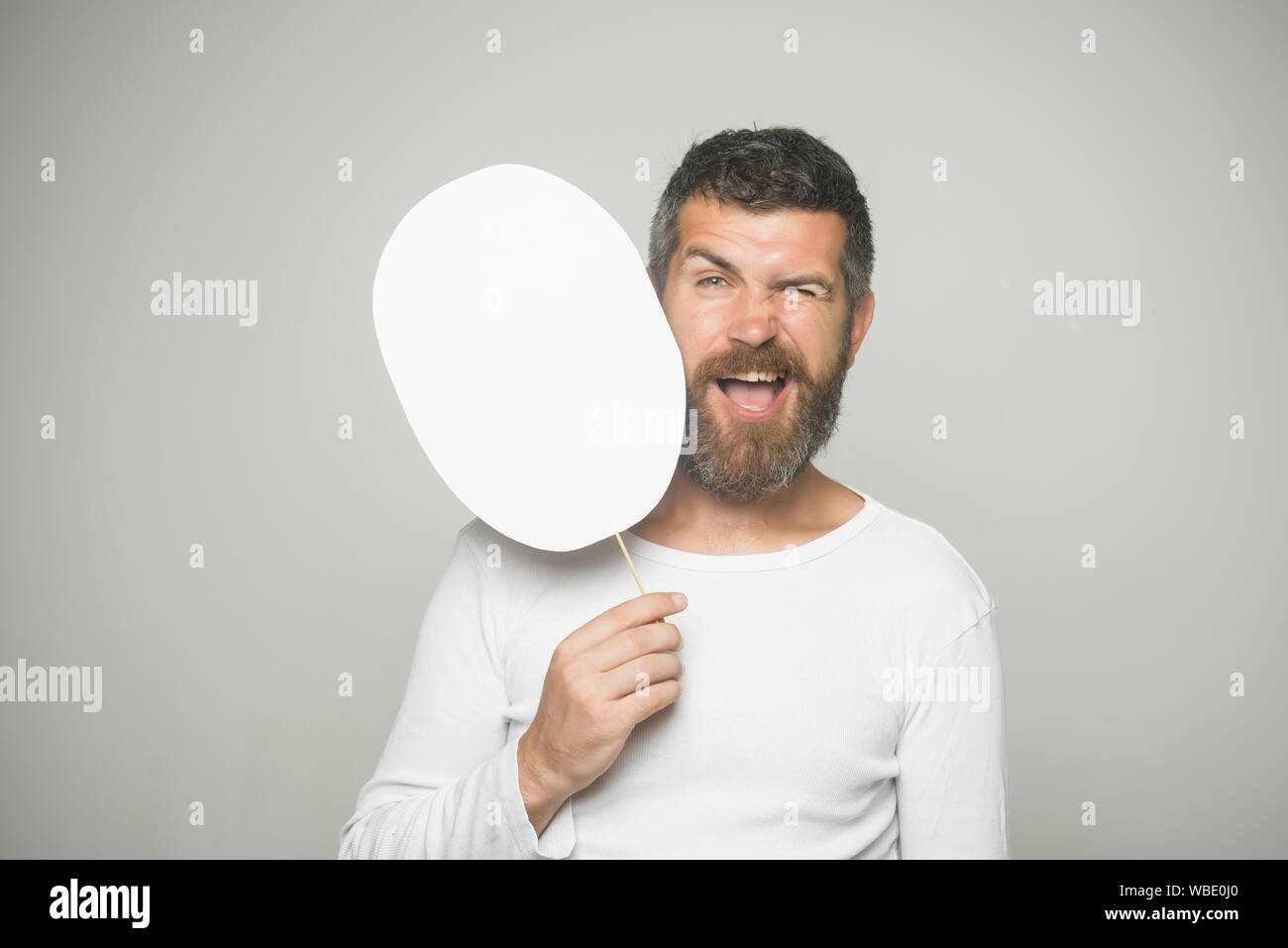 Hipster with winking face hold paper nameplate Stock Photo - Alamy