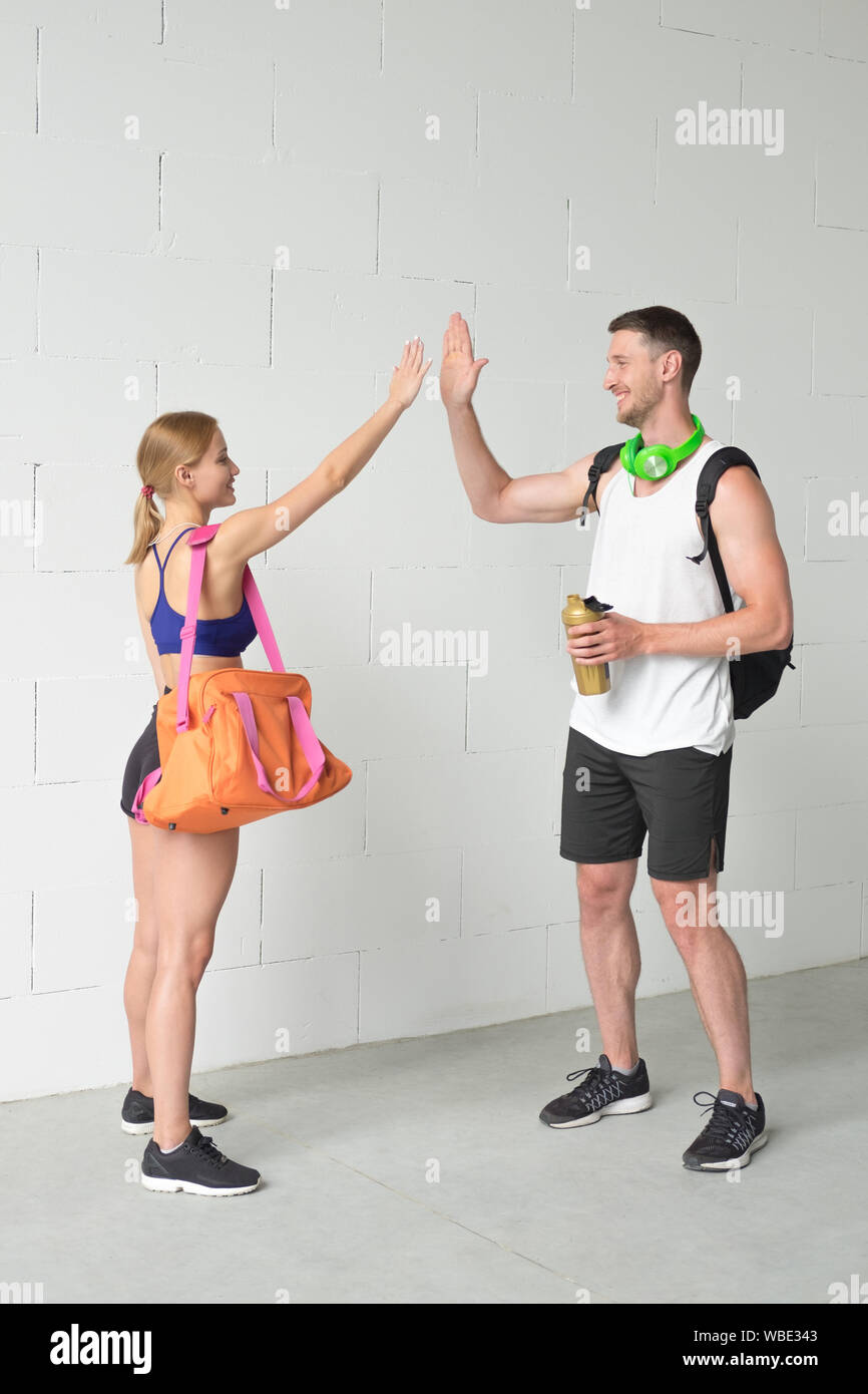 Fitness couple giving high five energetic and cheering Stock Photo - Alamy