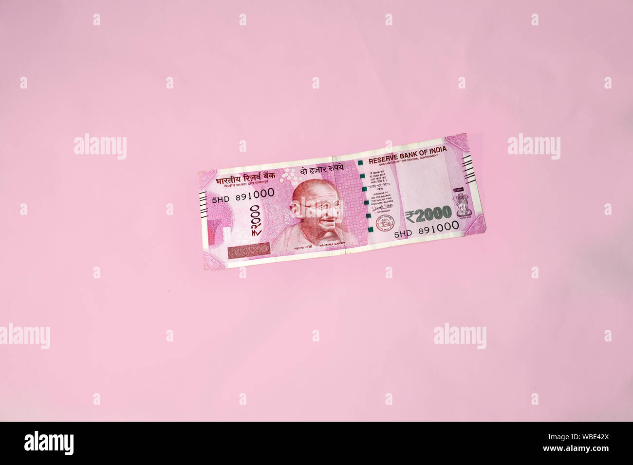 Modern Indian Two Thousand Rupees Currency Note on a minimal pink ...