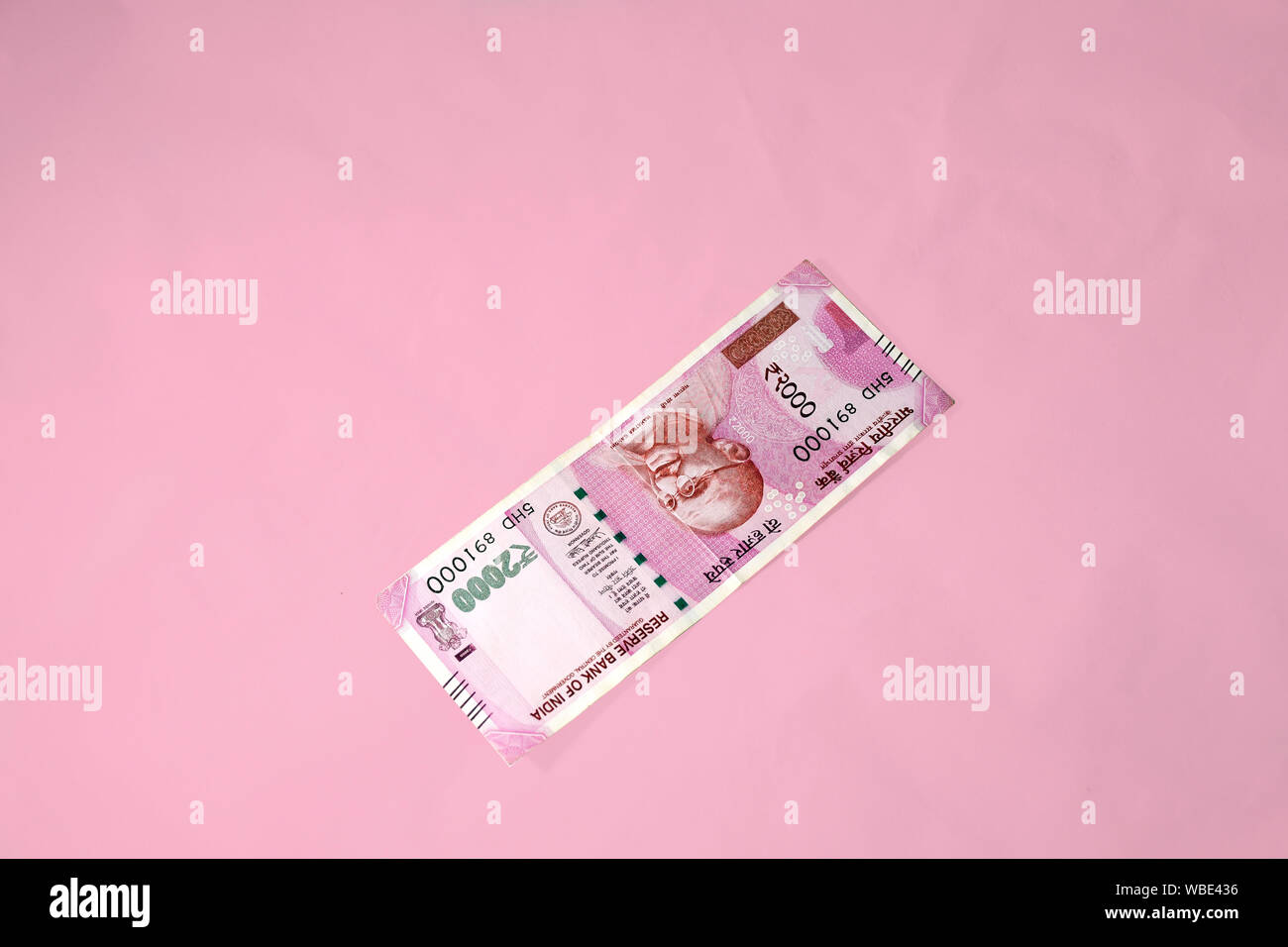 Modern Indian Two Thousand Rupees Currency Note on a minimal pink ...