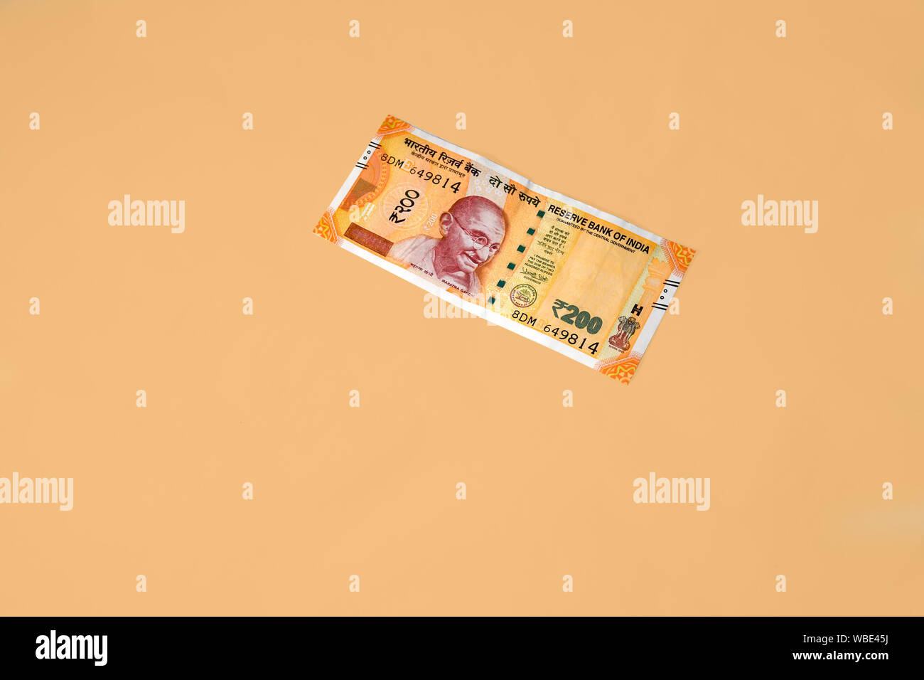 Modern Indian Two Hundred Rupees Currency Note on a minimal yellow ...