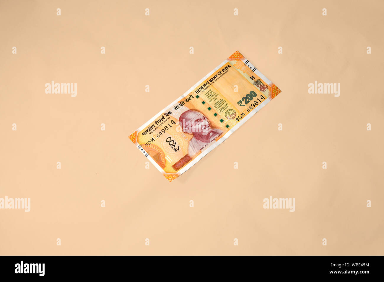 Modern Indian Two Hundred Rupees Currency Note on a minimal yellow ...