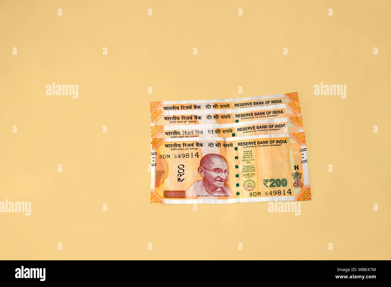 Modern Indian Two Hundred Rupees Currency Notes on a minimal yellow ...