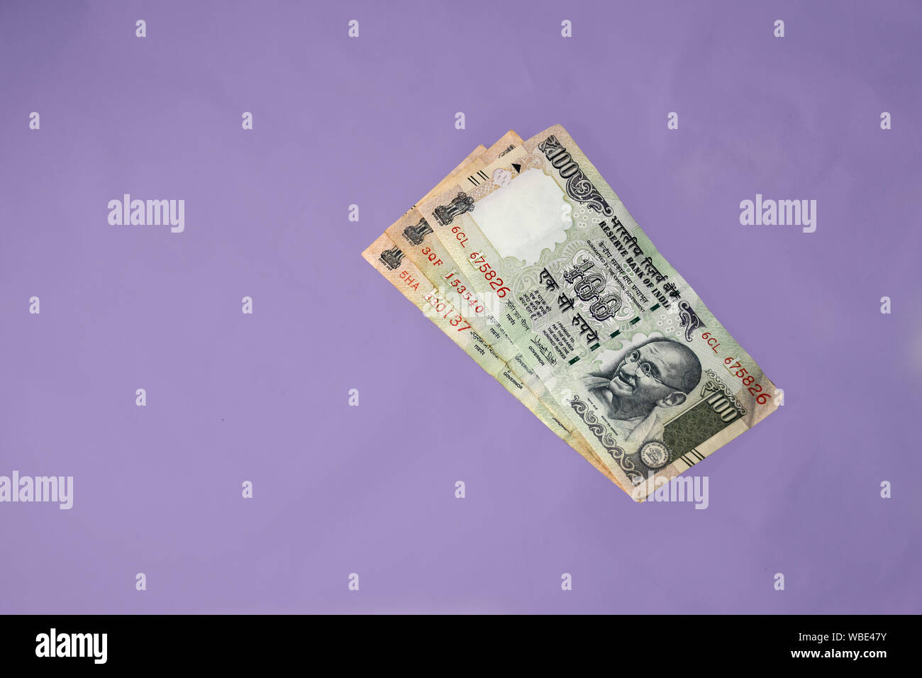 Old Indian One Hundred Rupees Currency Notes on a minimal purple ...