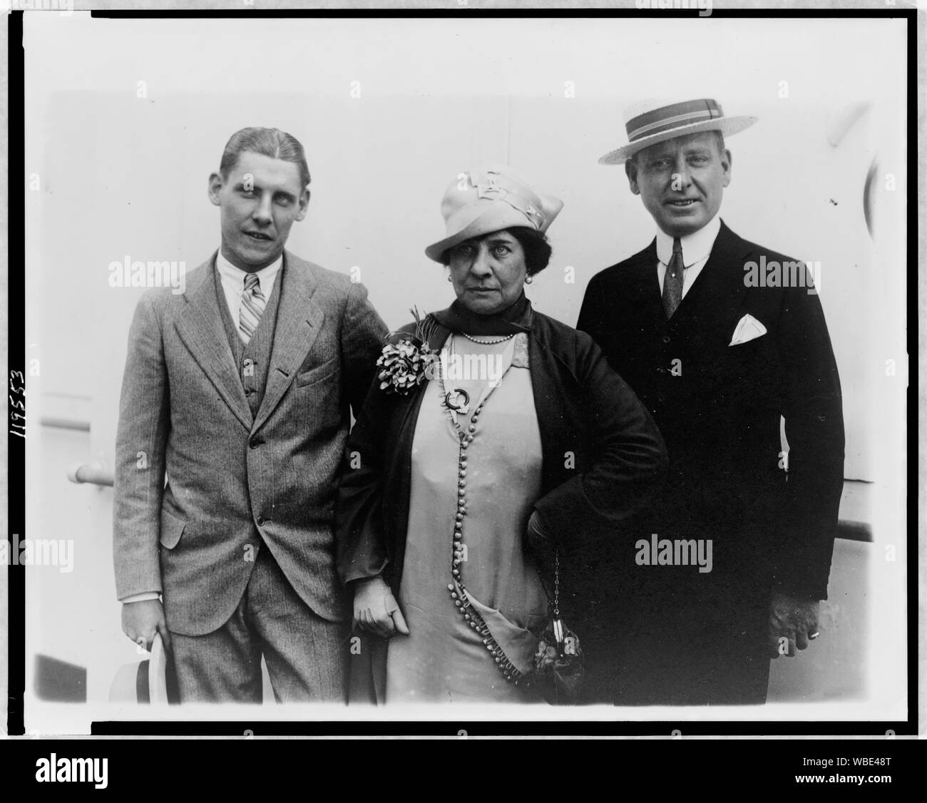 Frank Hague, his wife, and son, Frank, Jr., posed, standing, facing ...
