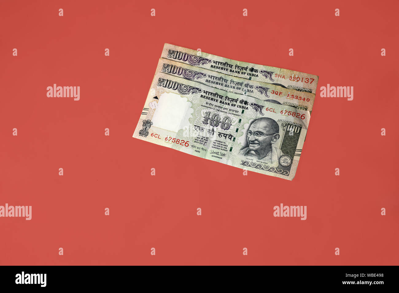 Old Indian One Hundred Rupees Currency Notes on a minimal orange ...