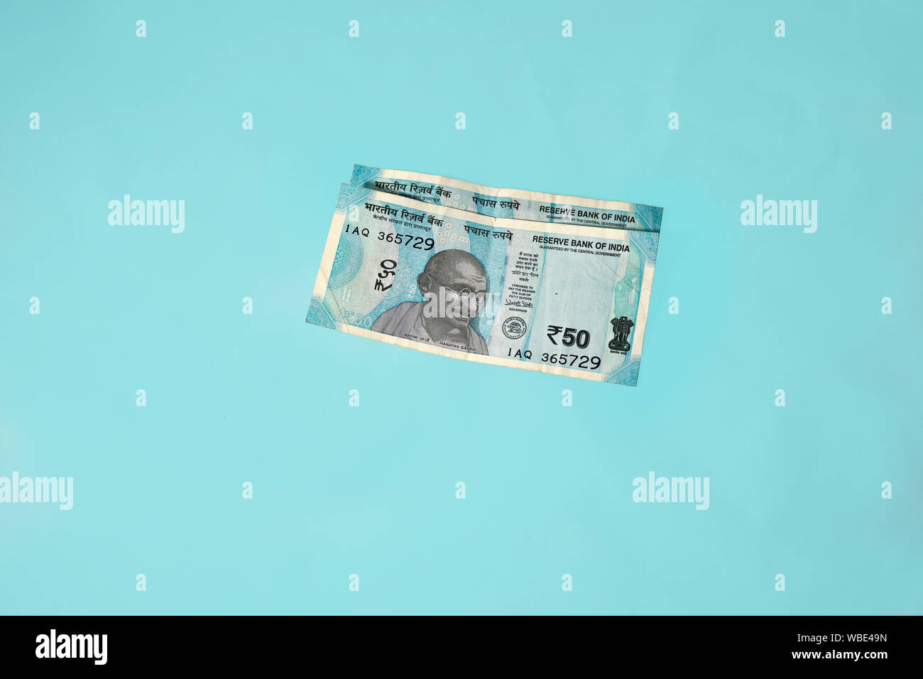 Modern Indian fifty Rupees Currency Notes on a minimal magenta ...