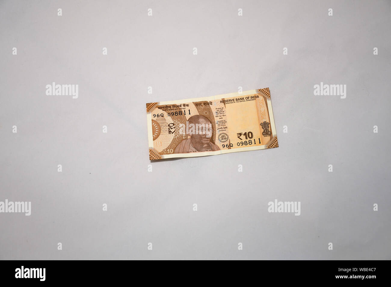 Modern Indian Ten Rupee Currency Note on a minimal gray background ...