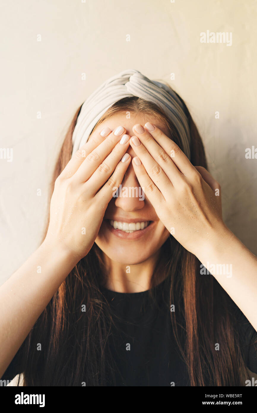 The girl covered her eyes with her hands Stock Photo - Alamy