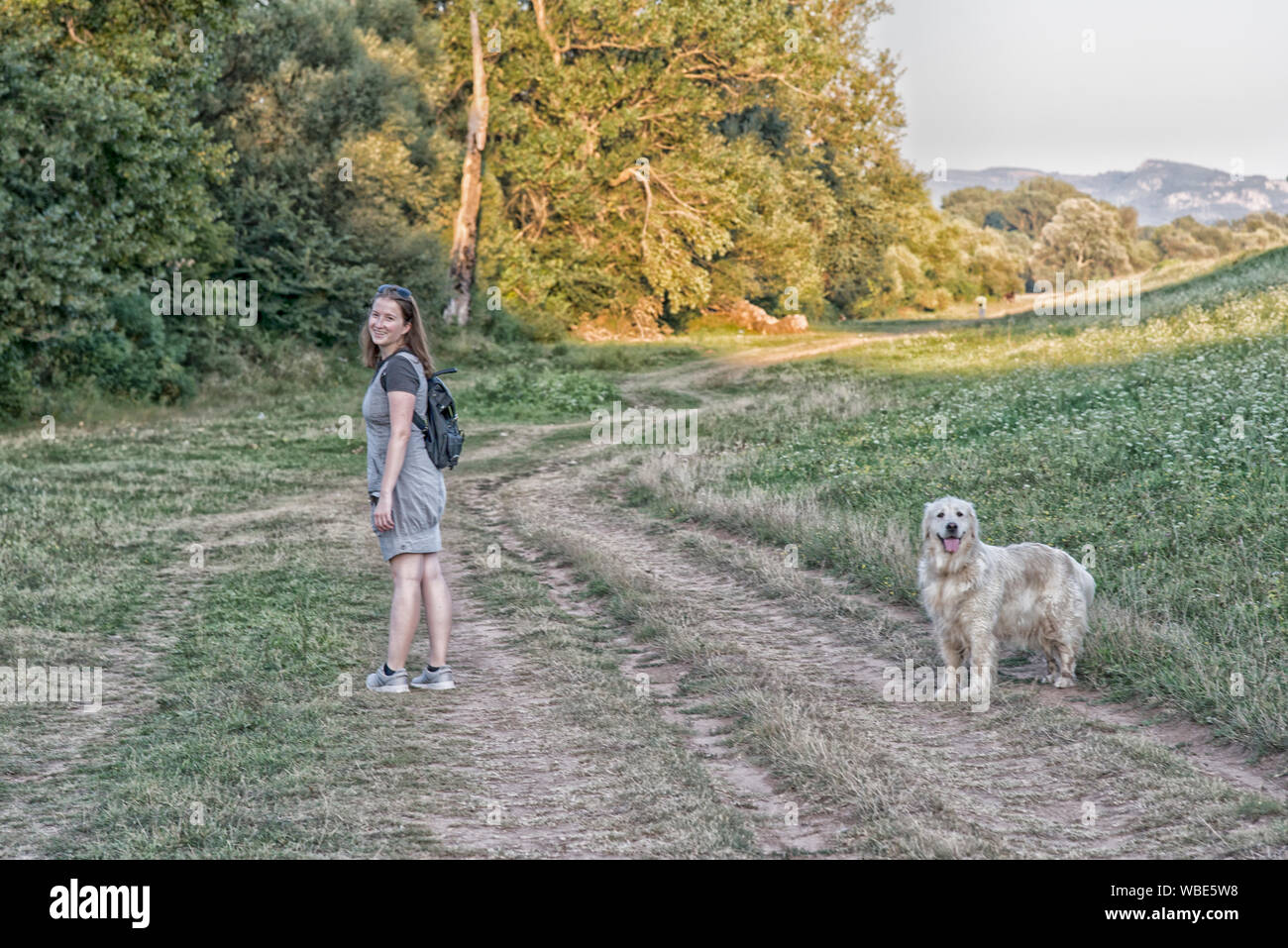 Woman and dog walking outdoor Stock Photo - Alamy