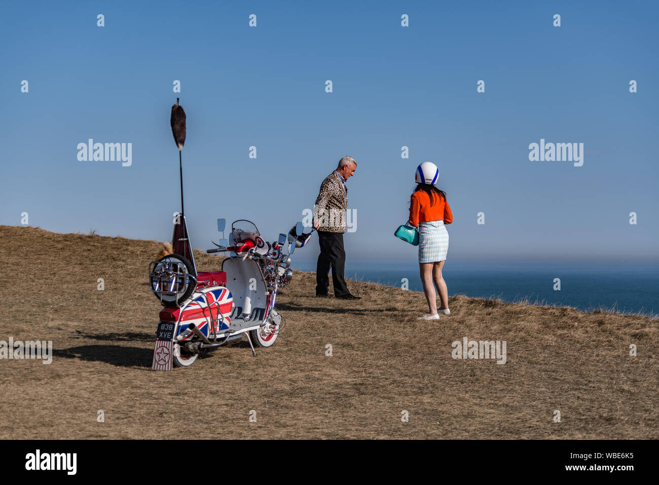 A mod couple look over the cliff edge at Beachy Head by their 1960s ...
