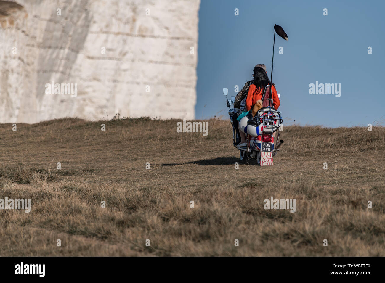 Mod couple on 60s Lambretta scooters ride up to Beachy Head, Eastbourne ...