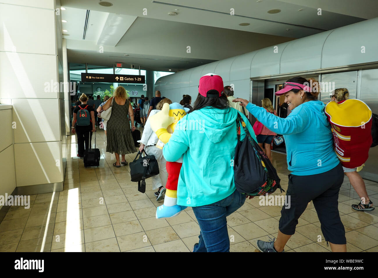 Orlando, FL/USA-8/22/19: People getting off a train at their airport ...