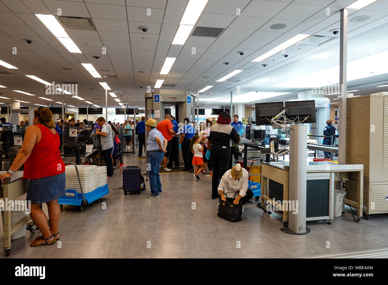Orlando, FL/USA-8/22/19: People at a busy airport security at a busy ...