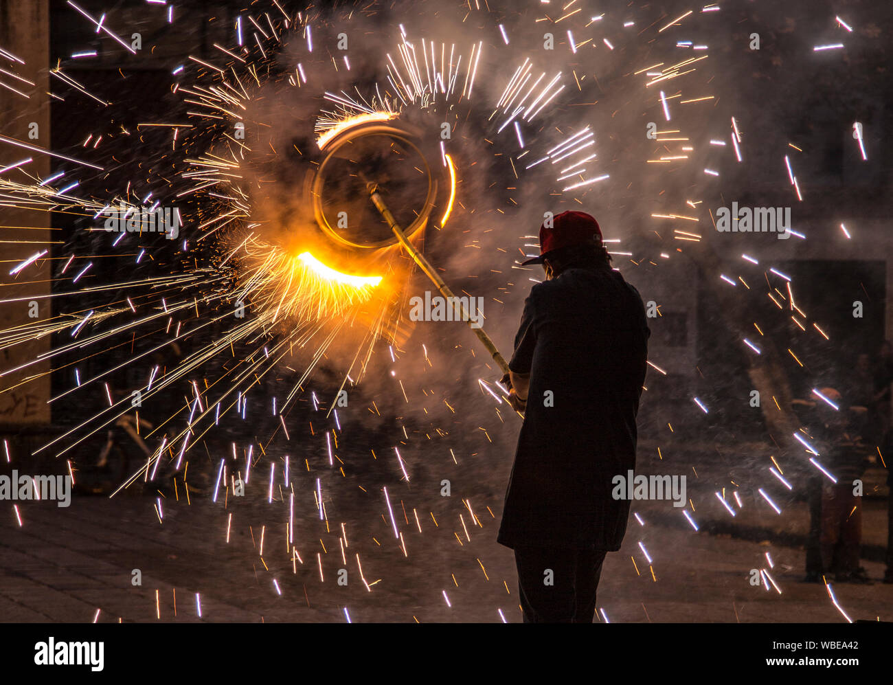 Cuenca, Ecuador - Nov 29, 2012: Man holds fireworks pinwheel at the end ...