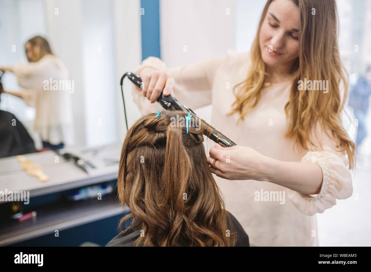 beauty, hairstyle concept, happy young woman and hairdresser with hair ...