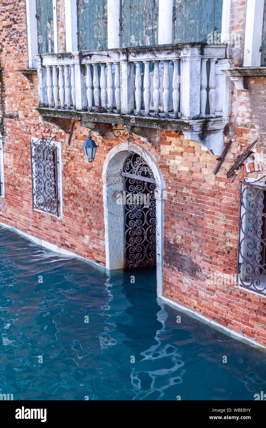 Building under water on Venice canal in Italy vertical Stock Photo - Alamy