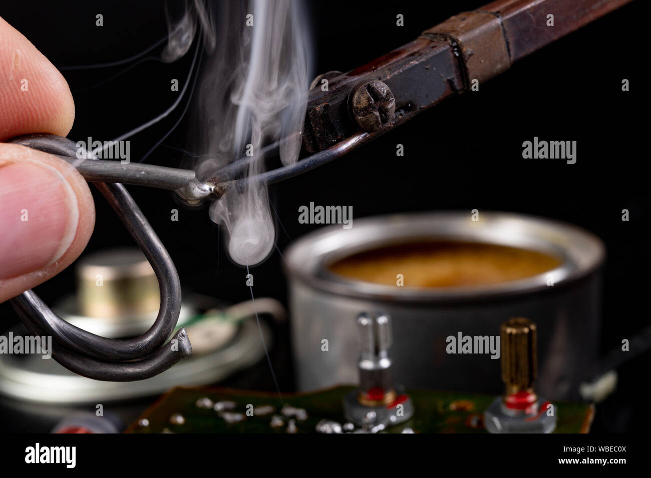 Soldering of an integrated circuit in an electronics workshop. Small ...