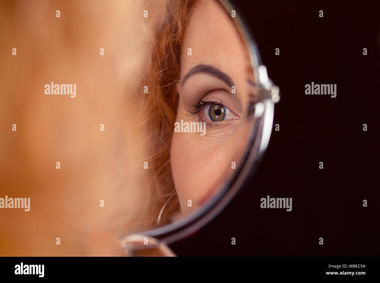 Female, woman's eye reflected in a round small mirror. Vision and ...