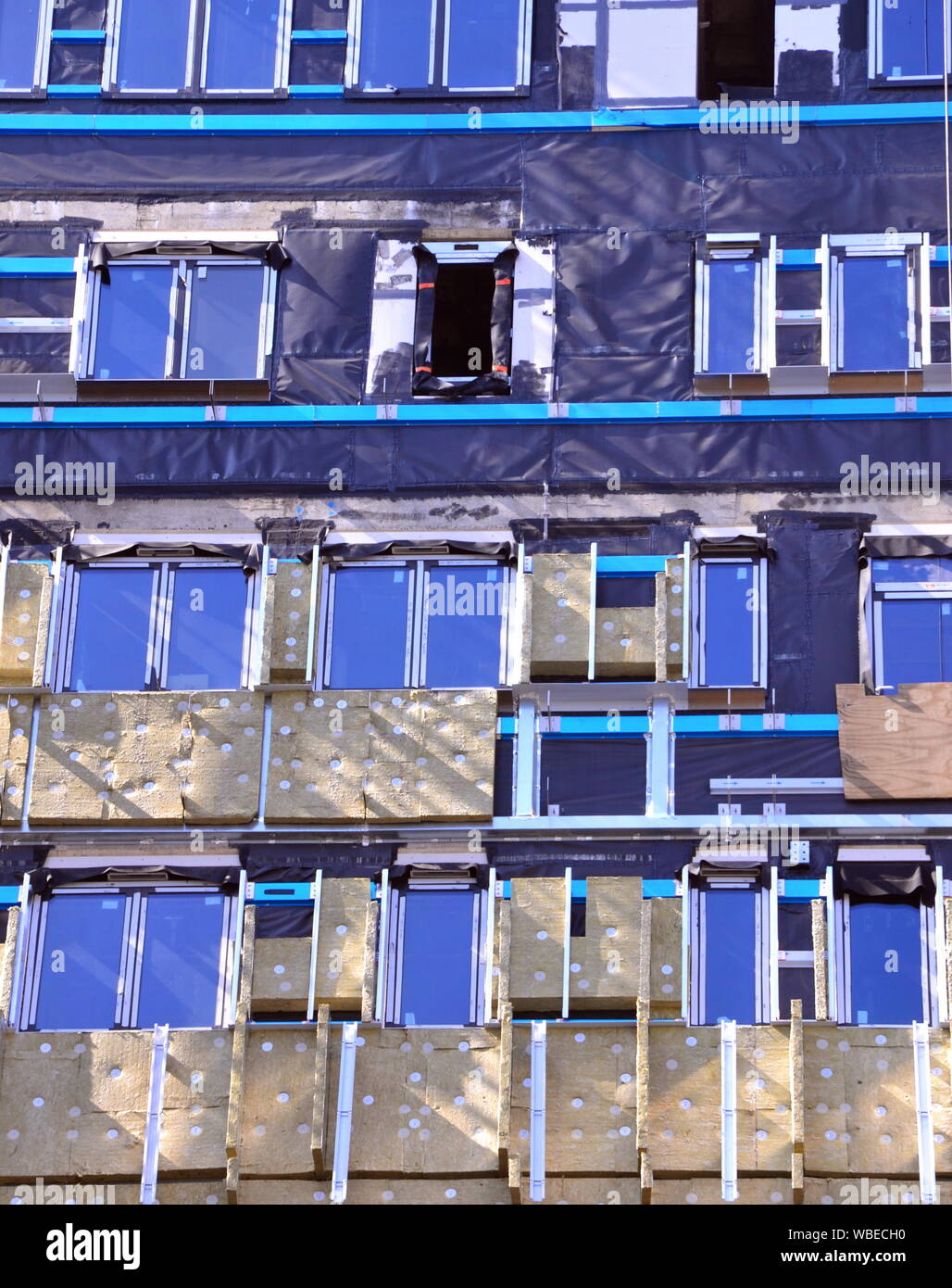 Uncompleted windows of a tower block under construction in central ...
