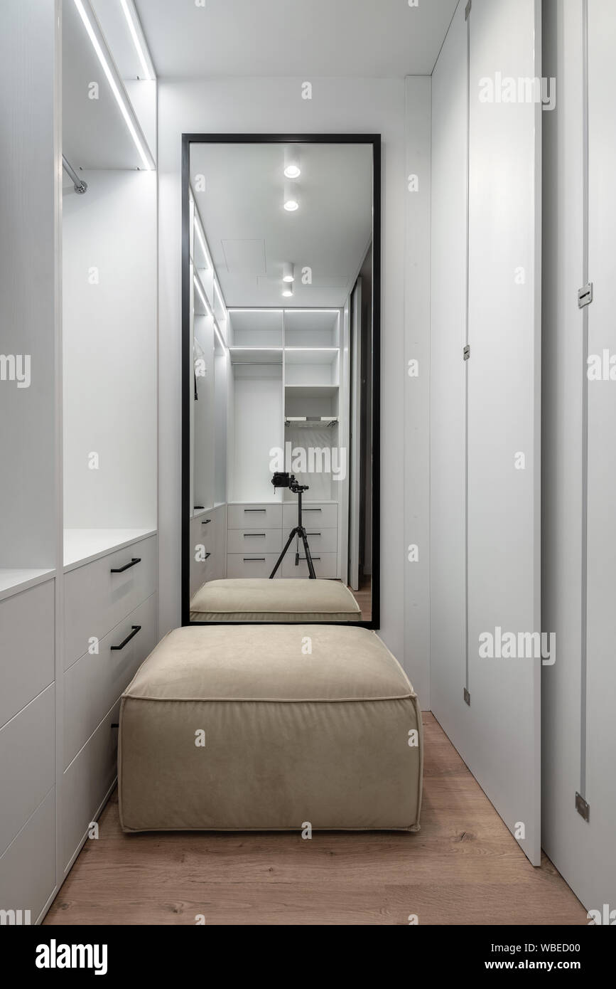 Light illuminated dressing room with a parquet on the floor. There are ...