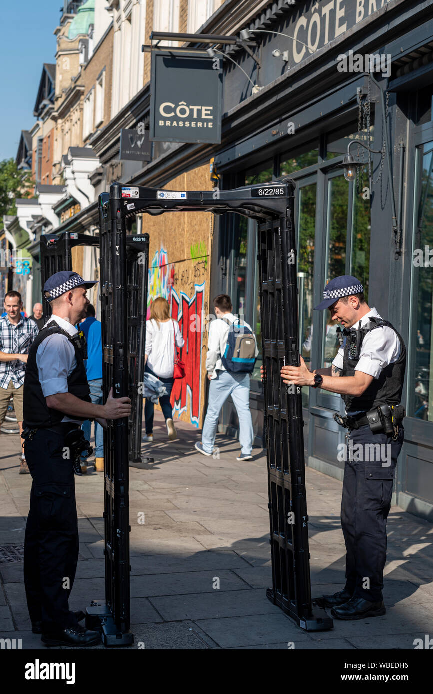 Police positioning portable metal knife detector arch at the Notting ...