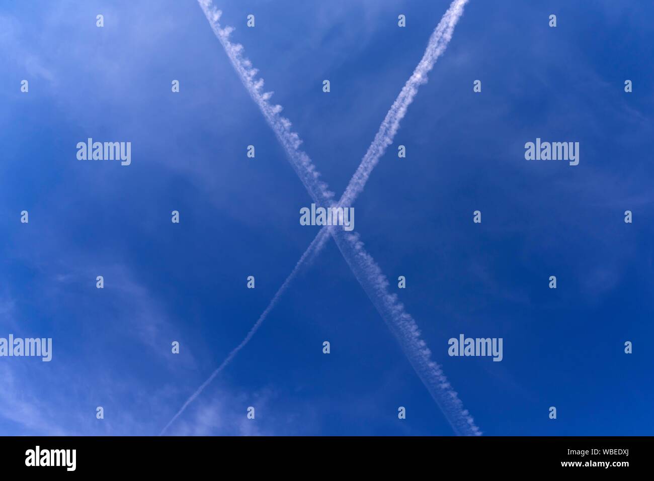 Crossing contrails in the blue sky, Bavaria, Germany Stock Photo - Alamy