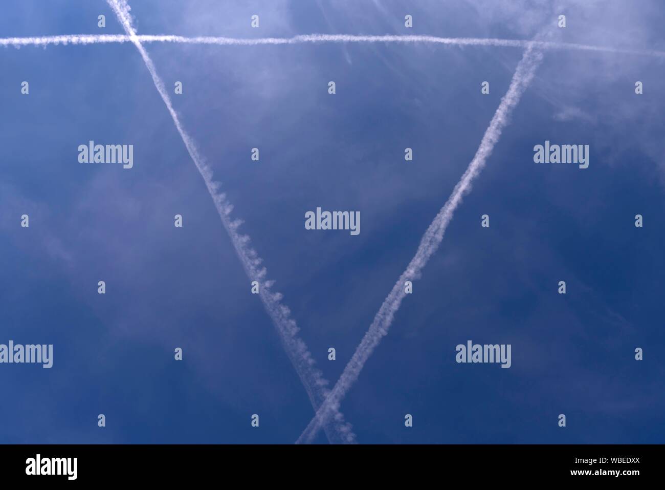 Crossing contrails in the blue sky, Bavaria, Germany Stock Photo - Alamy