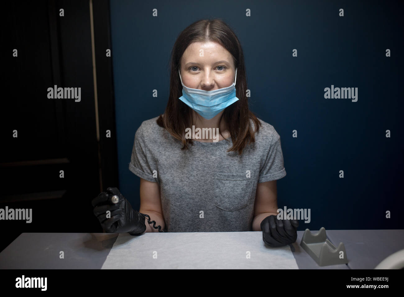 master with permanent machine. Portrait of a professional tattoo master ...