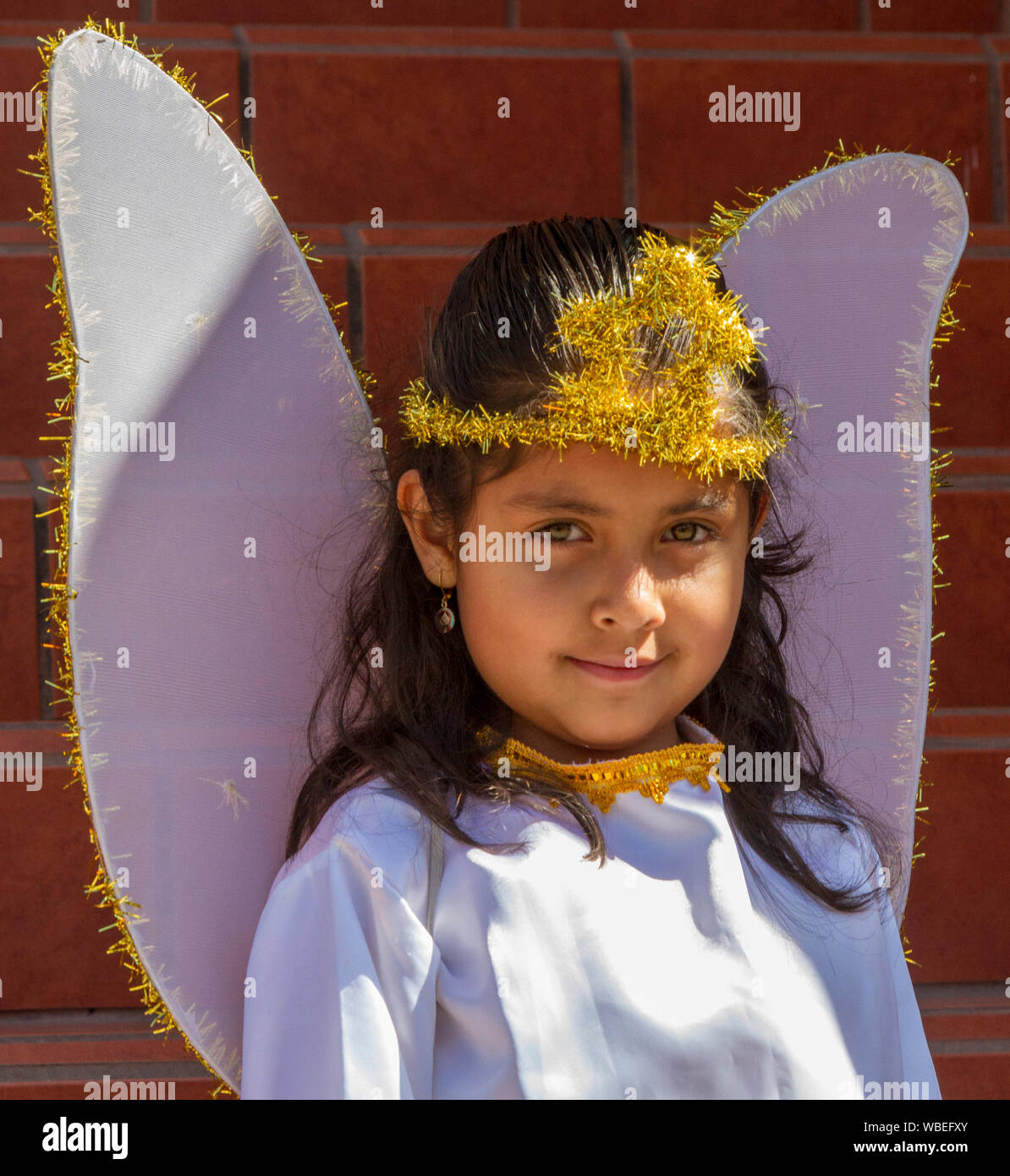 Girl dresses as angel for Christmas parade in Cuenca, Ecuador on Dec 24 ...