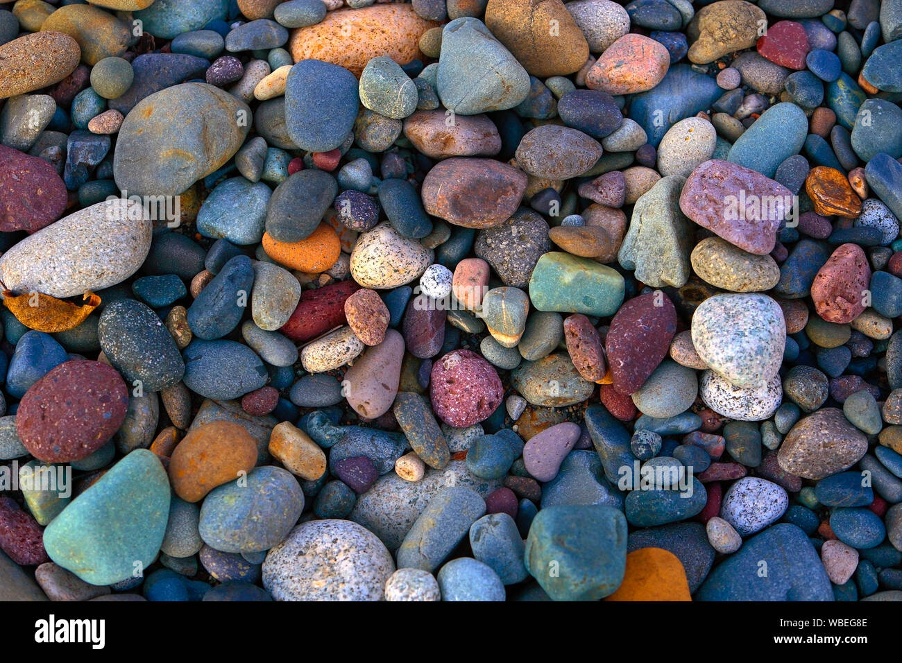 River Rock Pebbles in various sizes and shapes background Stock Photo ...